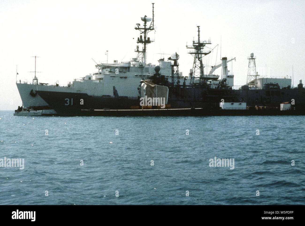 Damaged USS Stark (FFG-31) at Bahrain with USS La Salle (AGF-3) in May ...