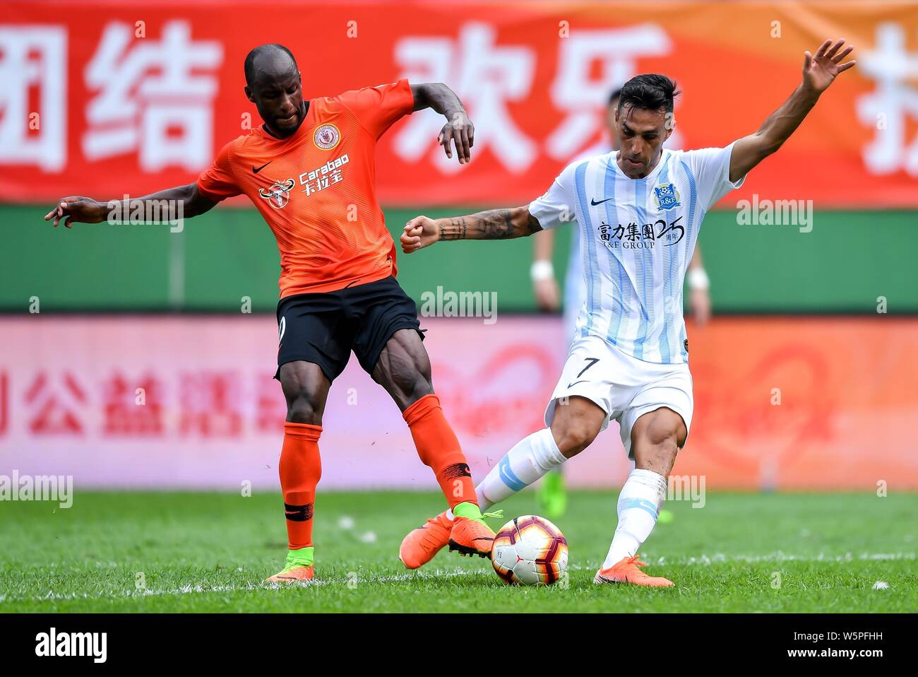 Israeli football player Eran Zahavi, right, of Guangzhou R&F passes the ...