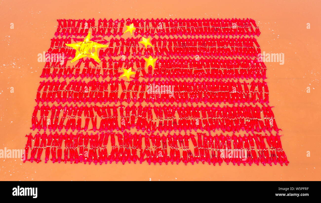 Swimmers create the pattern of a huge Five-starred Red Flag while ...