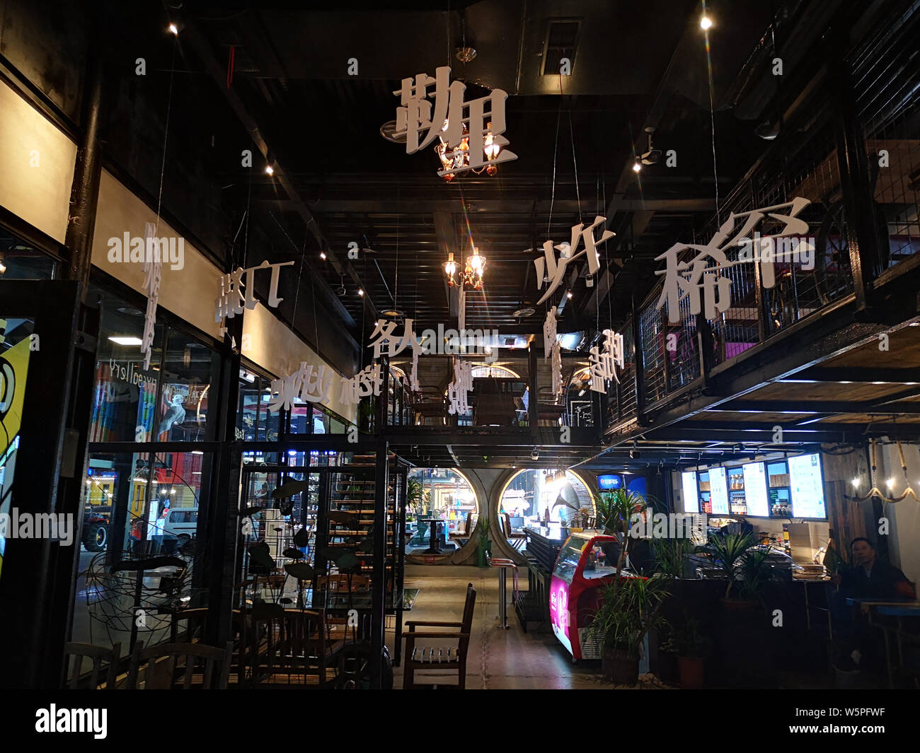 Chinese characters in the local dialect are hung from the ceiling in ...