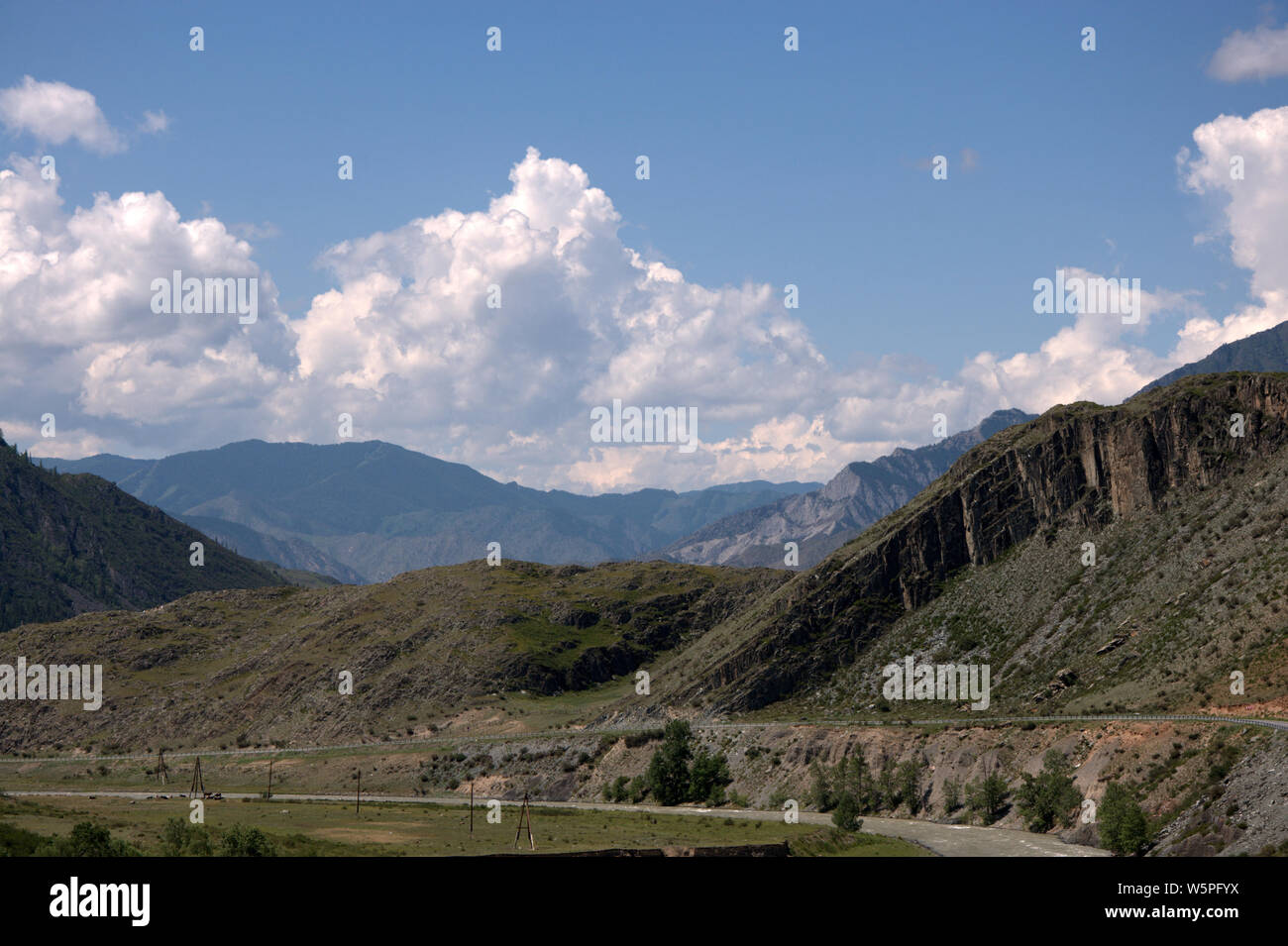 Poor pasture in spring, surrounded by high rocky hills. Altai, Siberia ...