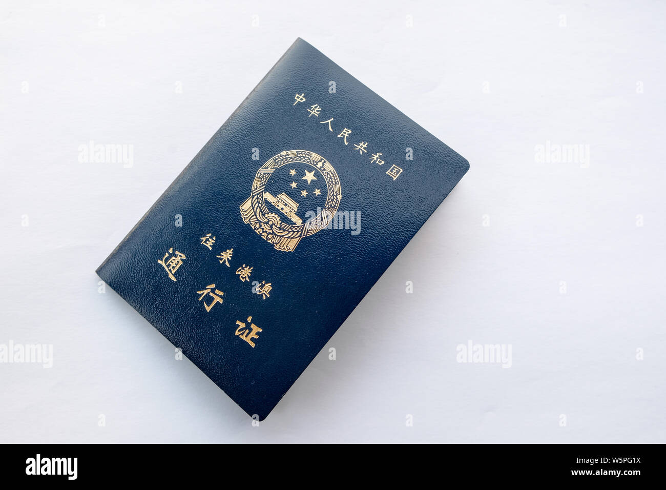 A police officer shows the passport-shaped travel pass for use between ...
