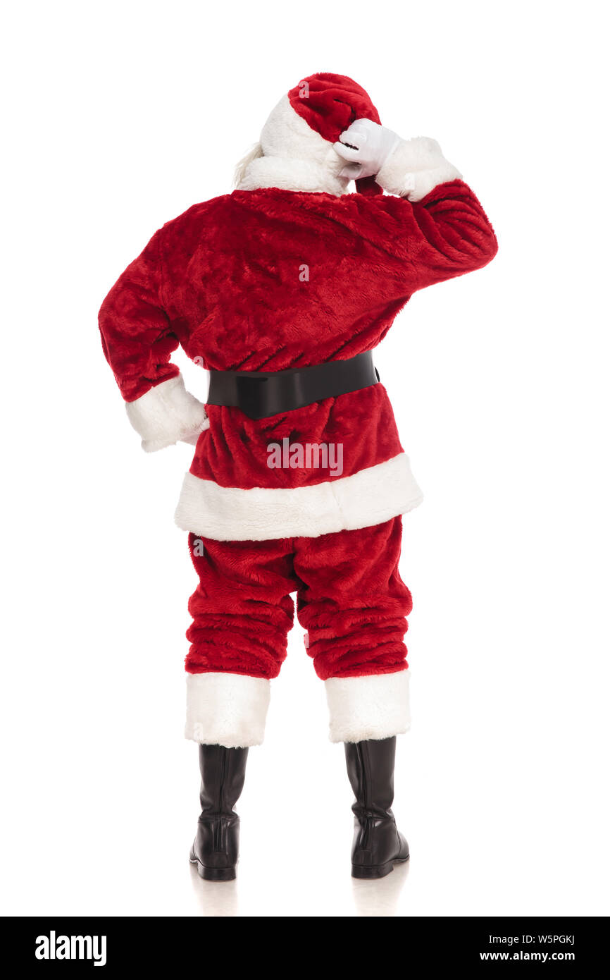back view of pensive santa claus standing on white background, full ...