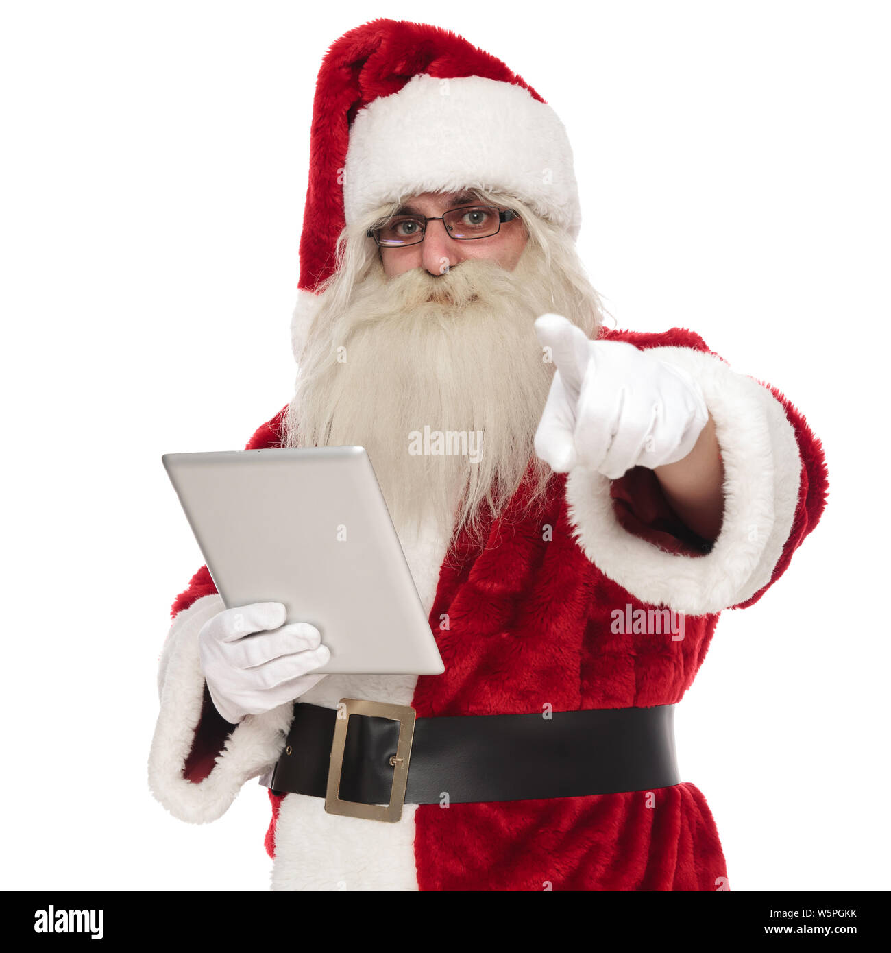portrait of santa holding tablet and pointing finger while standing on ...