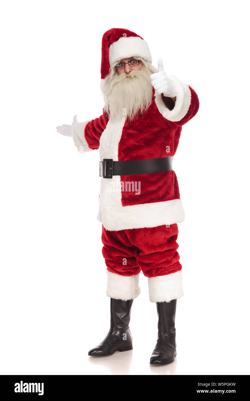 happy santa claus points finger and makes inviting gesture while ...