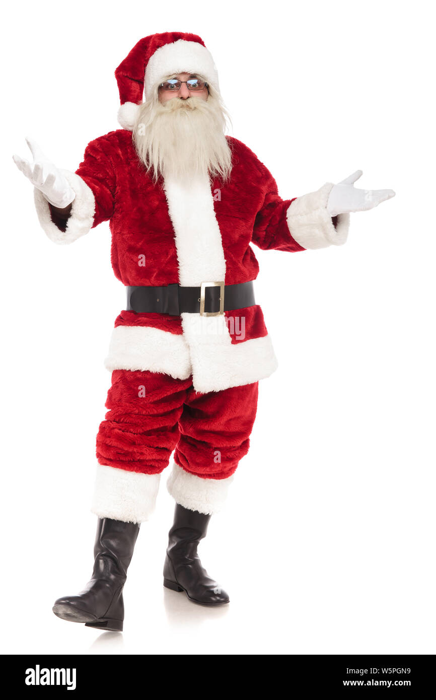 santa claus steps forward on white background and makes greeting ...