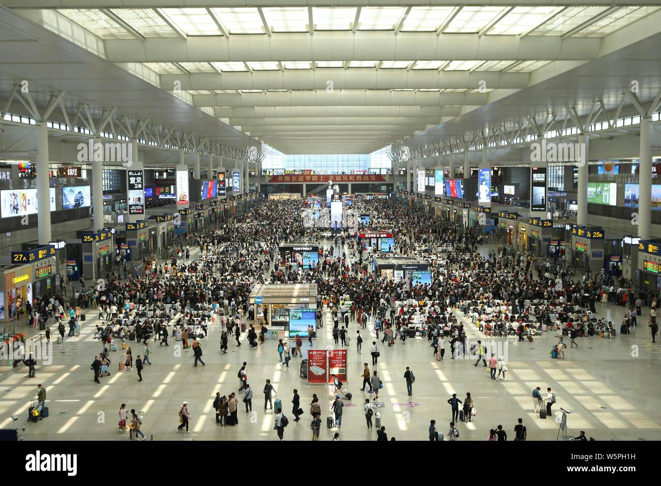 Chinese passengers wait for their trains during the four-day Labor Day ...
