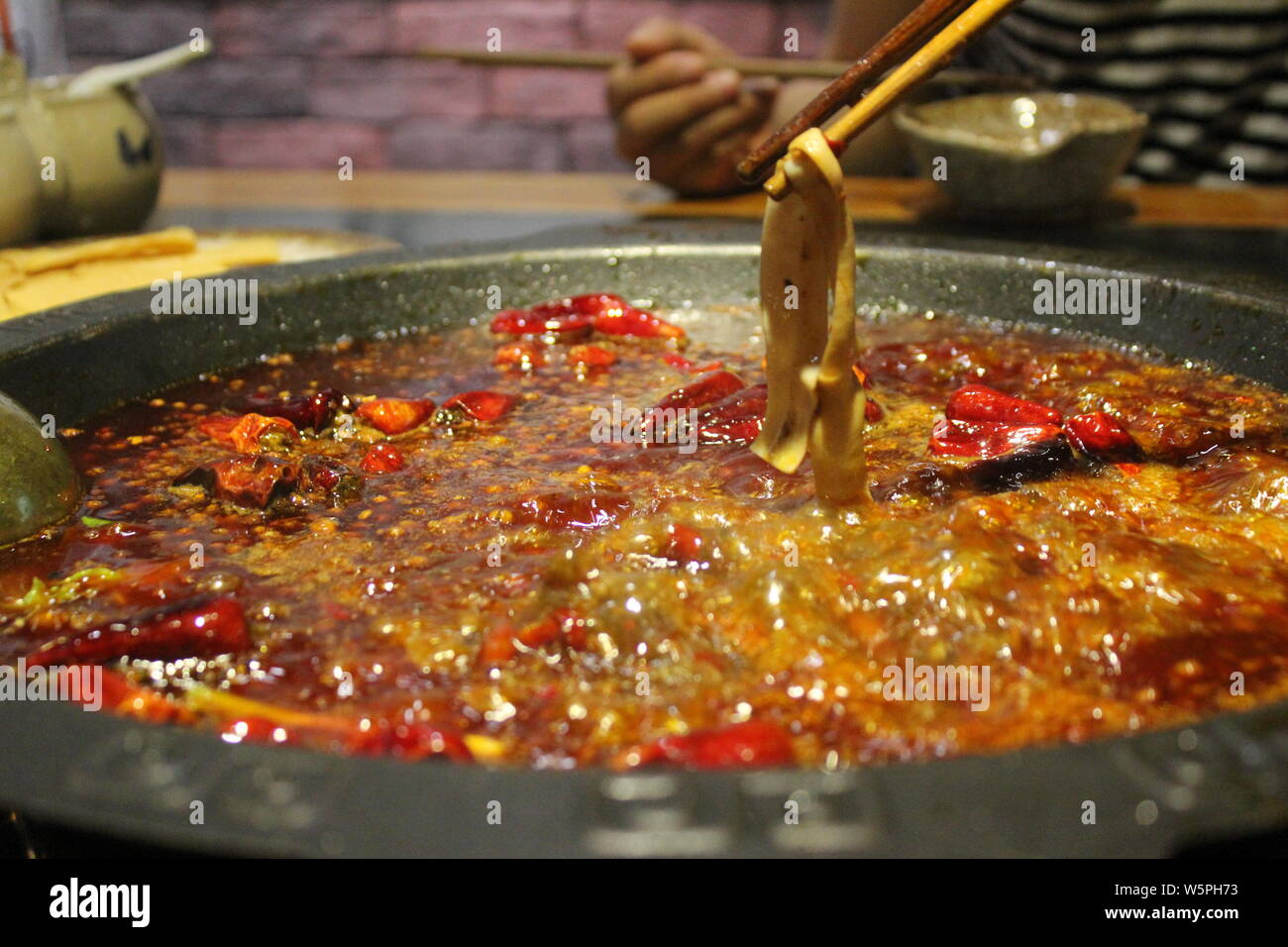 --FILE--Customers enjoy a spicy hot pot at a hotpot restaurant in ...