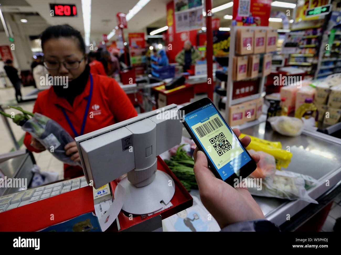 --FILE--A local resident uses his smartphone to have the QR code ...