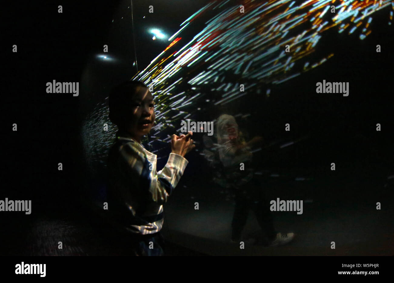 Visitors view an immersive digital art exhibition themed around big ...