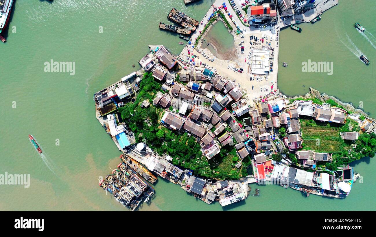 A cluster of colorful houses is seen at a village in Wenling city, east ...
