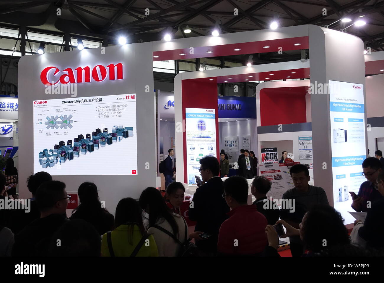 --FILE--People visit the stand of Canon during an exhibition in ...
