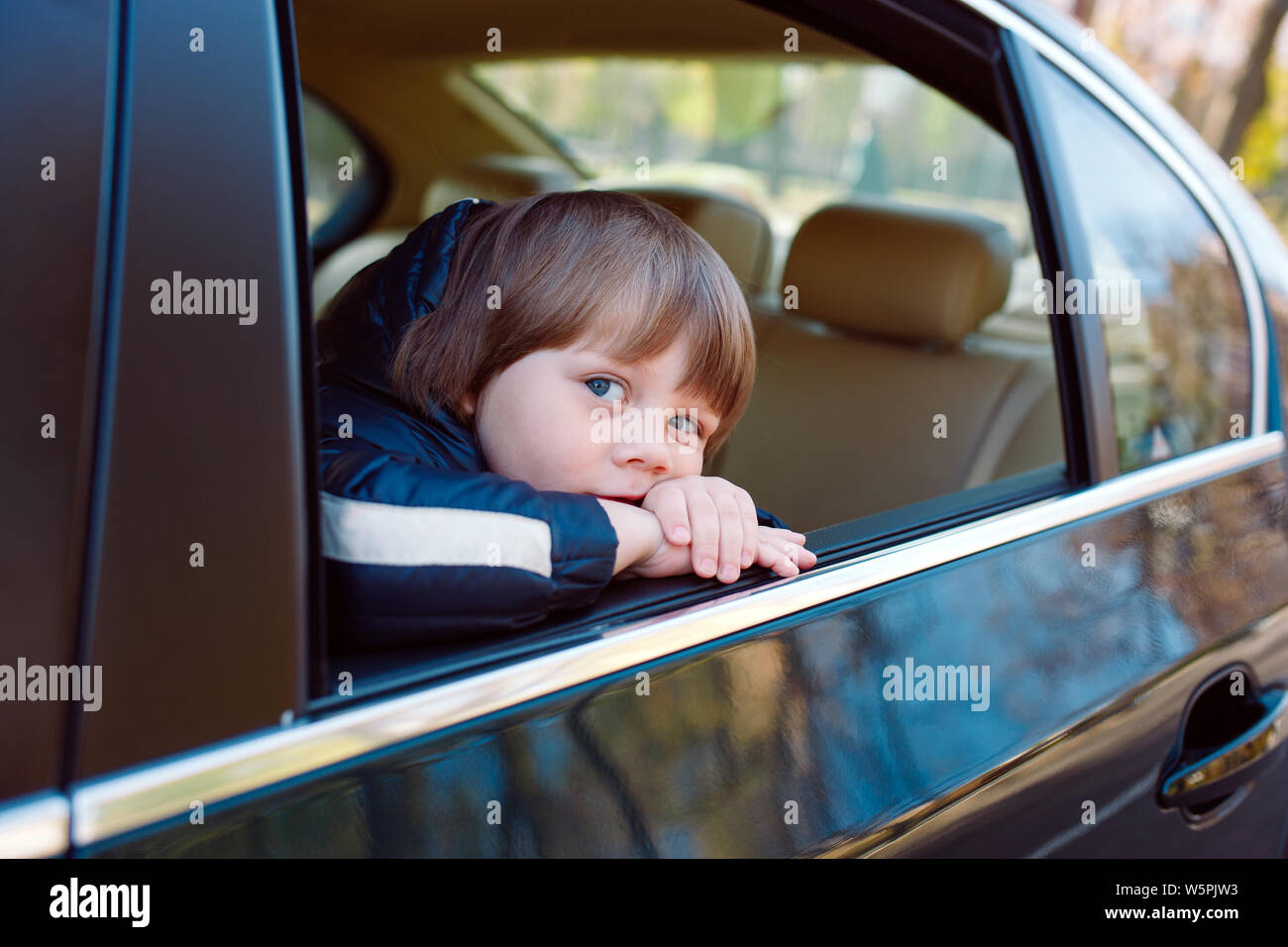 Baby boy in the car behind the wheel Stock Photo - Alamy