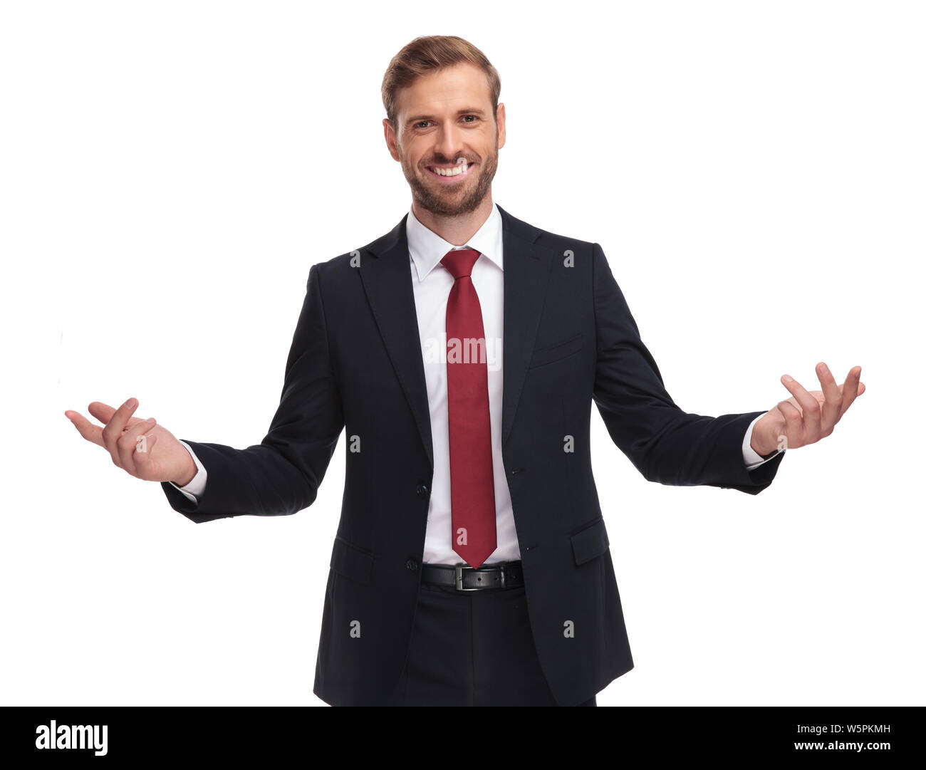 portrait of handsome businessman smiling and making an inviting gesture ...