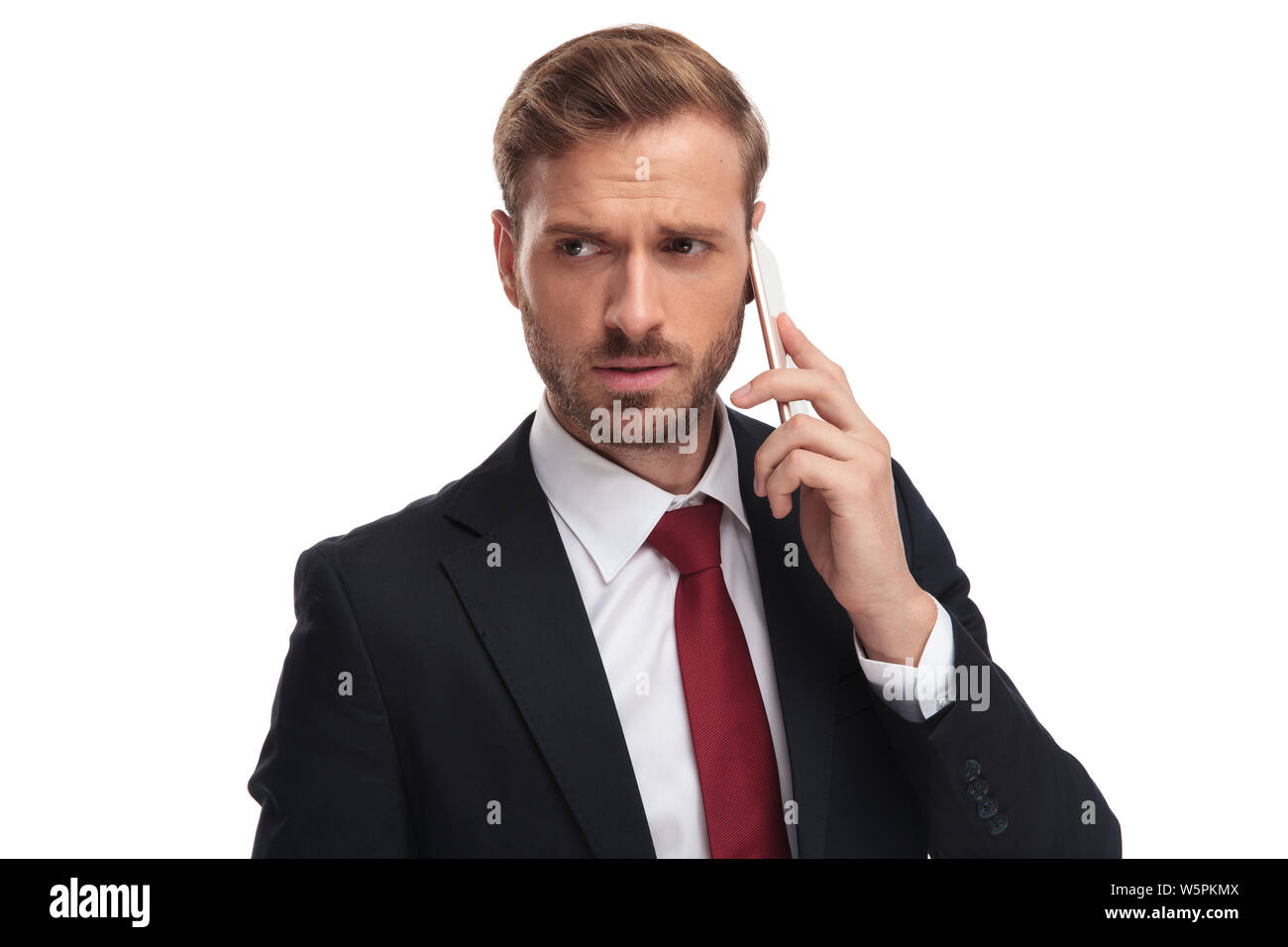 portrait of anxious businessman talking on the phone and looking to ...