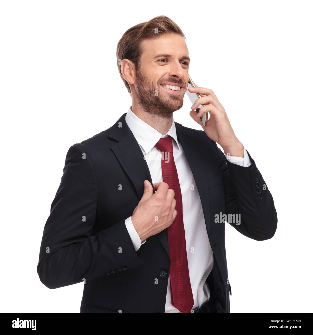 portrait of laughing businessman speaking on the phone while fixing ...