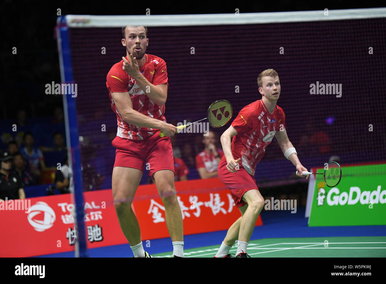 Kim Astrup and Anders Skaarup Rasmussen of Denmark return a shot to Li ...