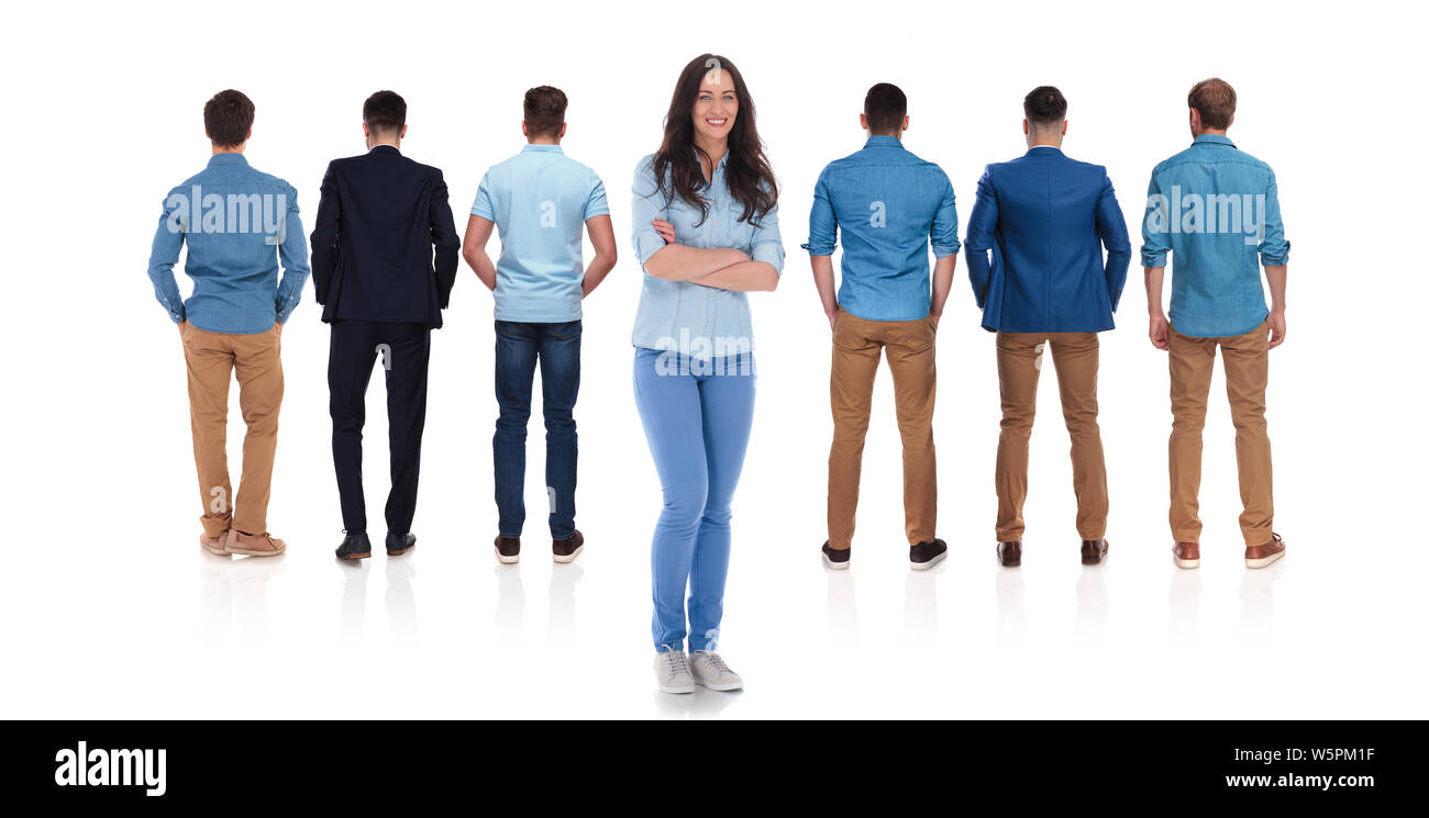back view of team of seven colleagues standing on white background with ...