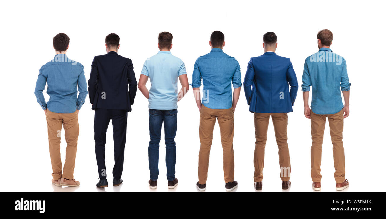 back view of six relaxed young men wearing suits and blue shirts ...