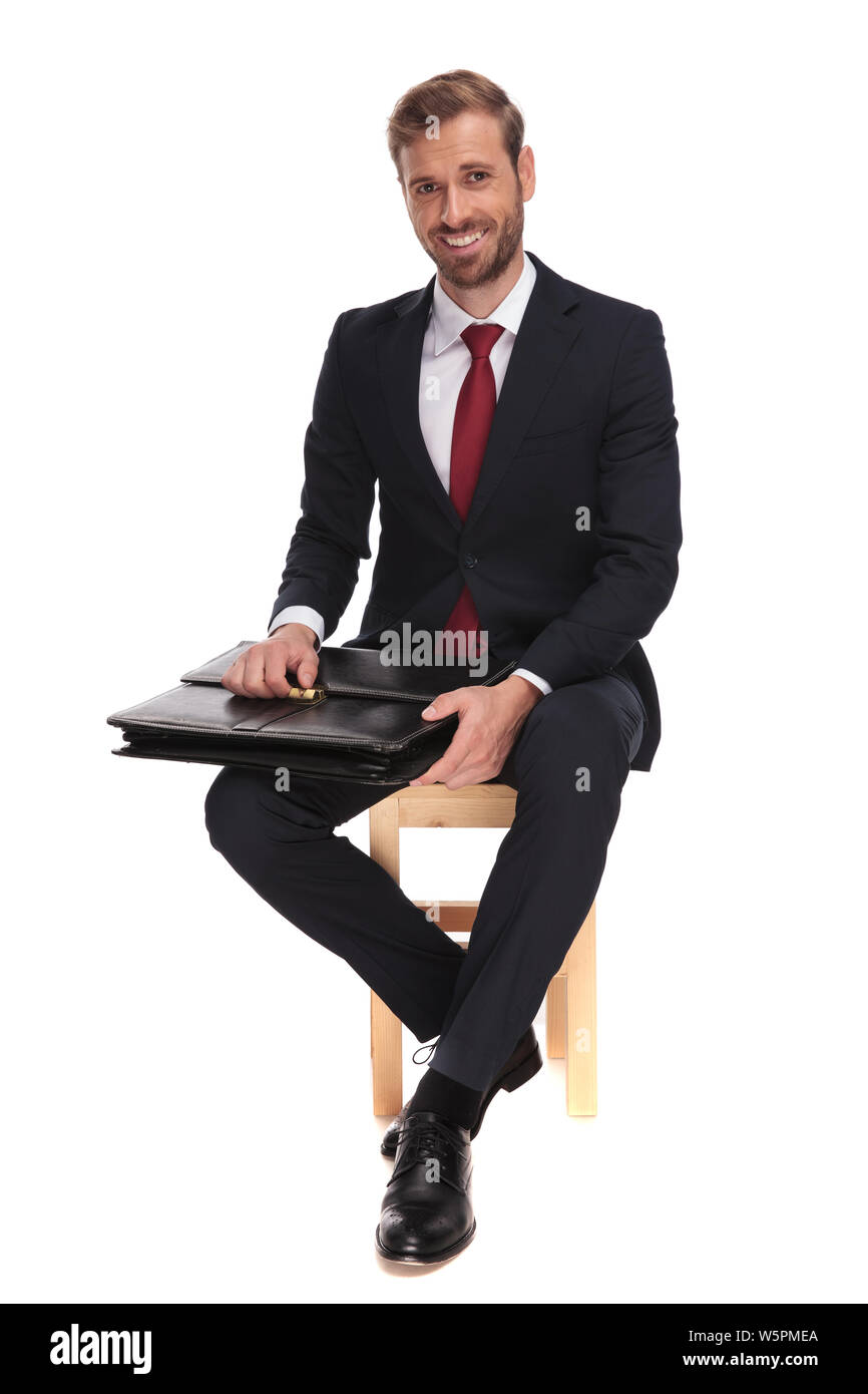 seated businessman waiting for job interview and opening suitcase while ...