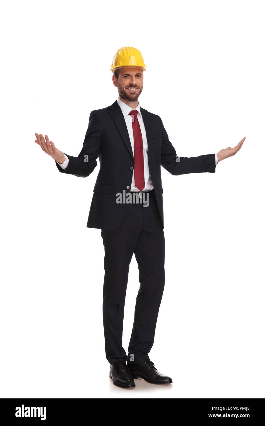 engineer ceo makes a welcoming hand gesture while smiling and standing ...