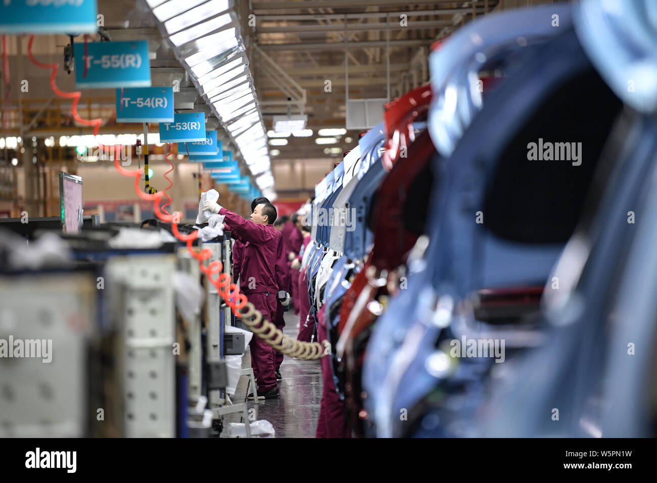 Chinese workers assemble vehicles on the assembly line at the auto ...