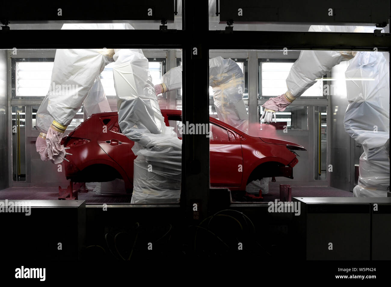 Chinese workers assemble vehicles on the assembly line at the auto ...