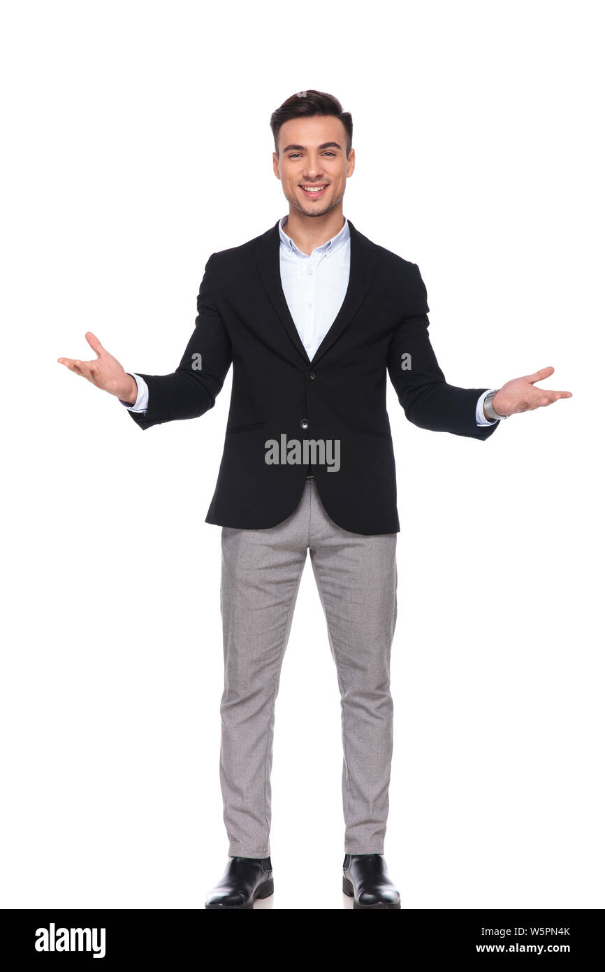 smiling businessman in black suit making an open hand gesture while ...
