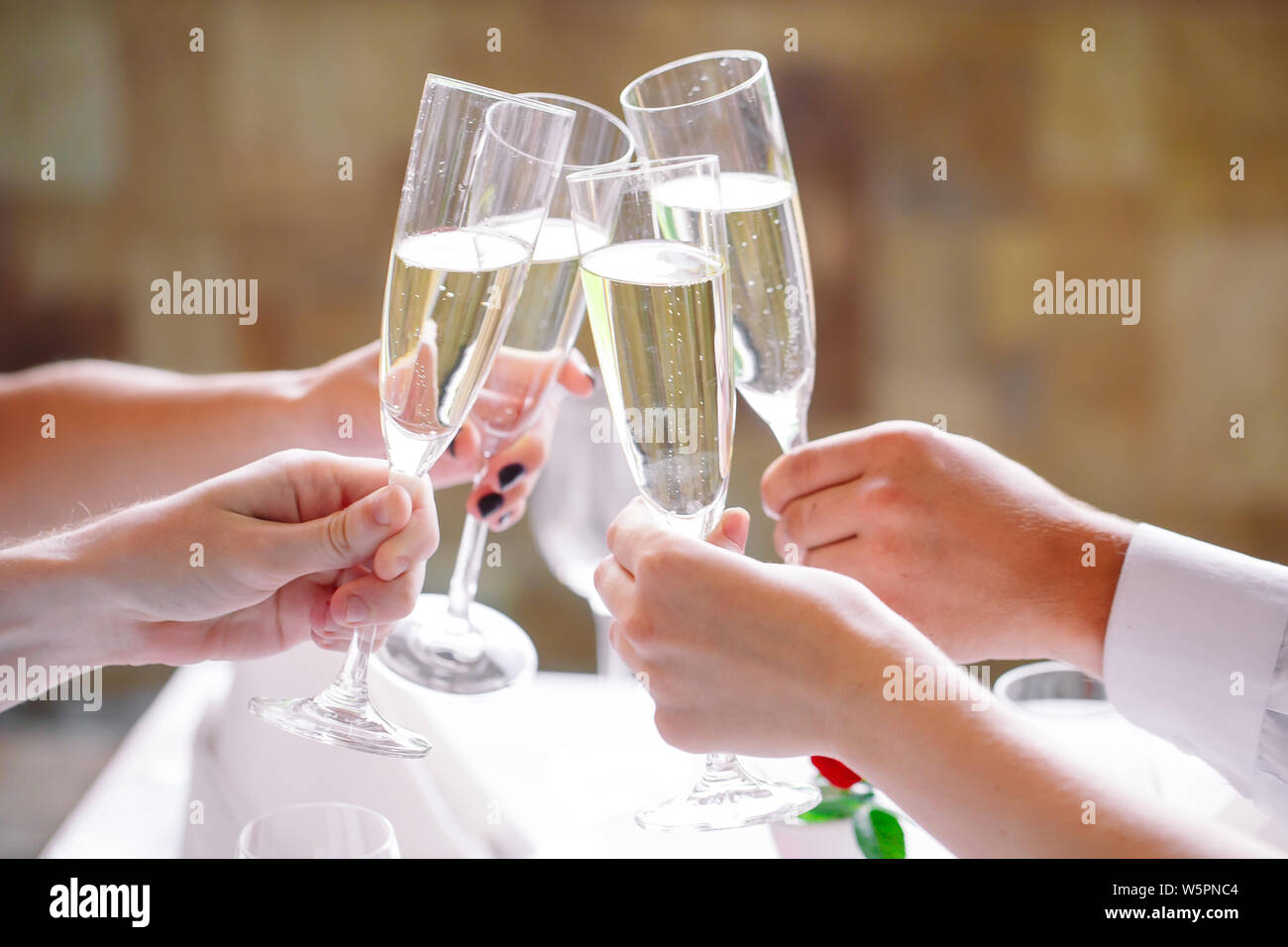 Friends in the restaurant having a toast Stock Photo - Alamy