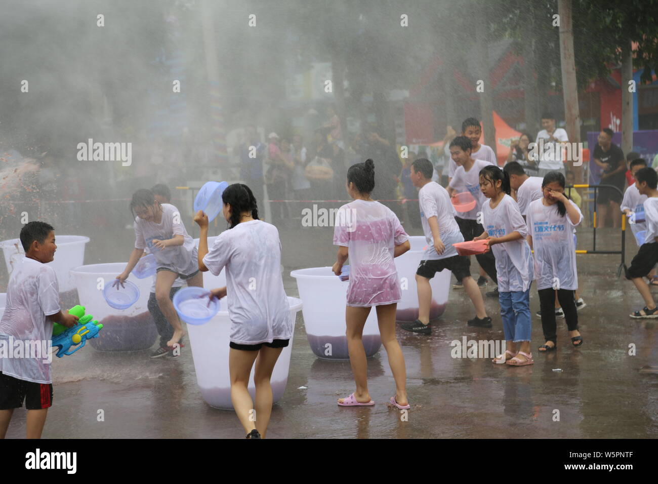 People sprinkle wine to each other to celebrate the 2nd Wine Culture ...