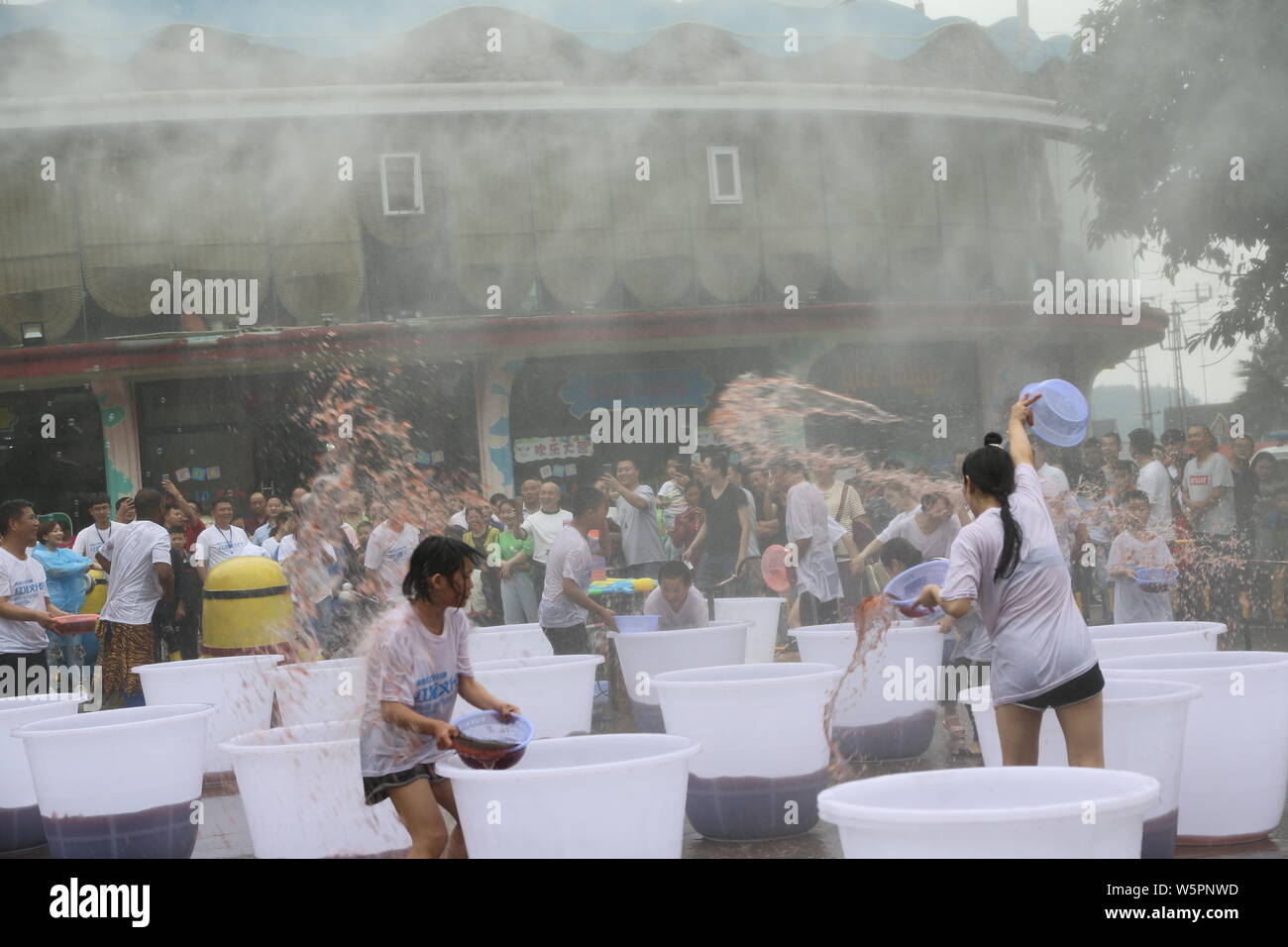 People sprinkle wine to each other to celebrate the 2nd Wine Culture ...