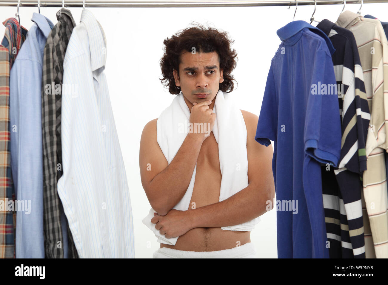 Man deciding what to wear Stock Photo - Alamy