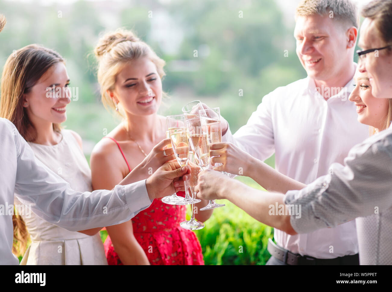 Friends in the restaurant having a toast Stock Photo - Alamy