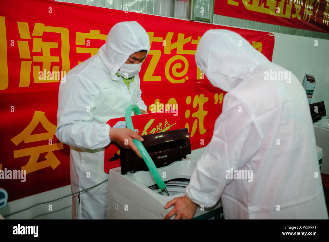 In this undated photo, Chinese workers clean lobsters through using ...
