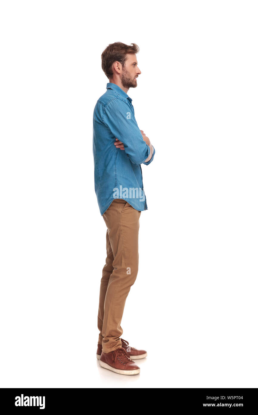 young casual man standing in line with hands crossed on white ...