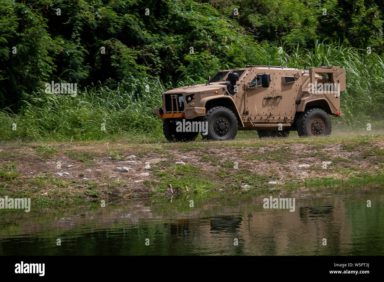 U.S. Marines with 3d Marine Regiment drive a Joint Light Tactical ...