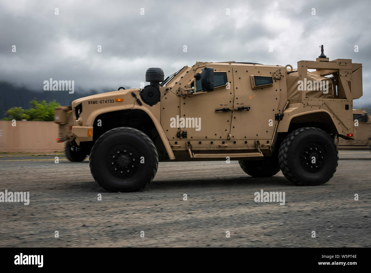U.S. Marines with 3d Marine Regiment drive a Joint Light Tactical ...