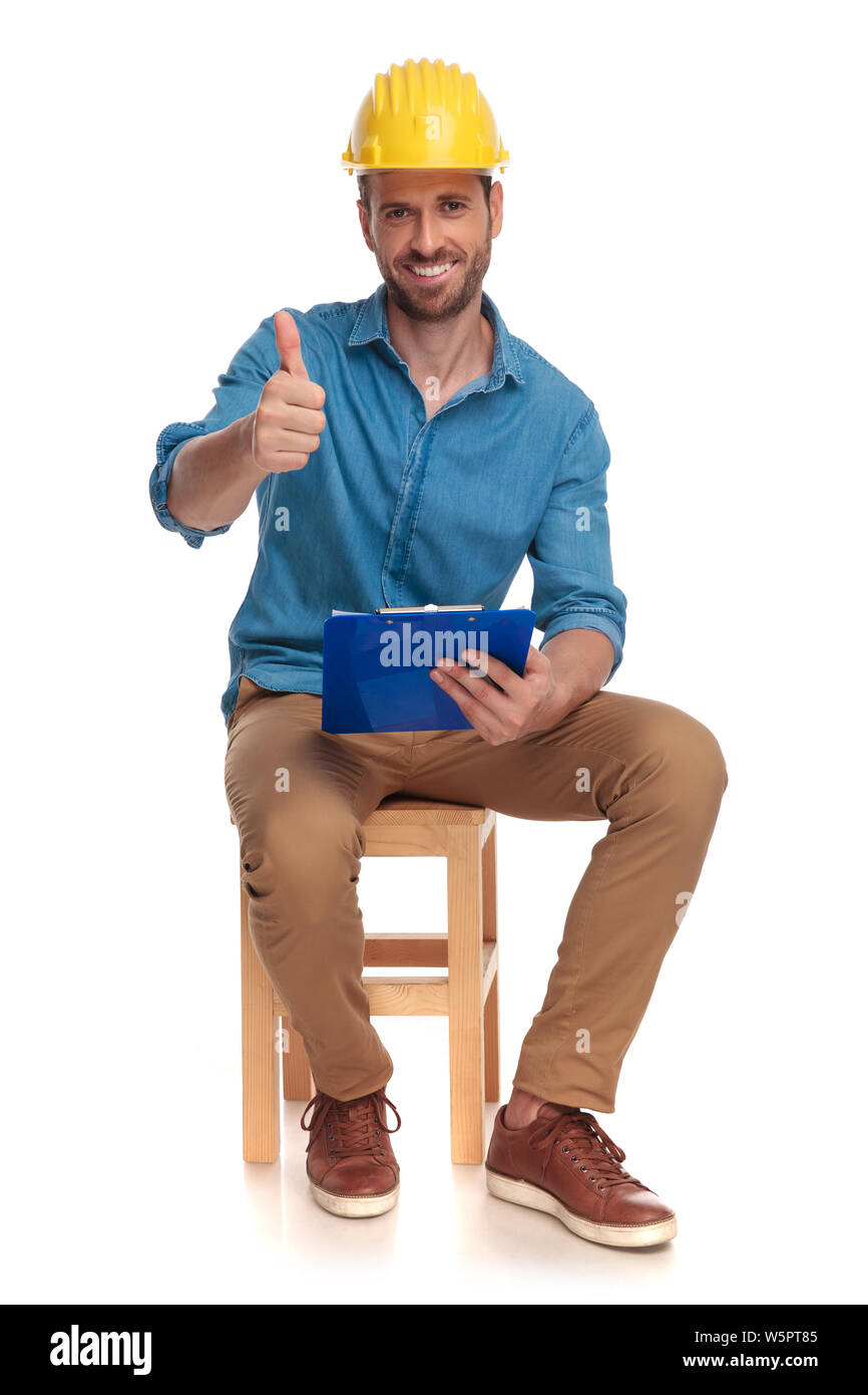 happy construction engineer making the ok sign while sitting on chair ...