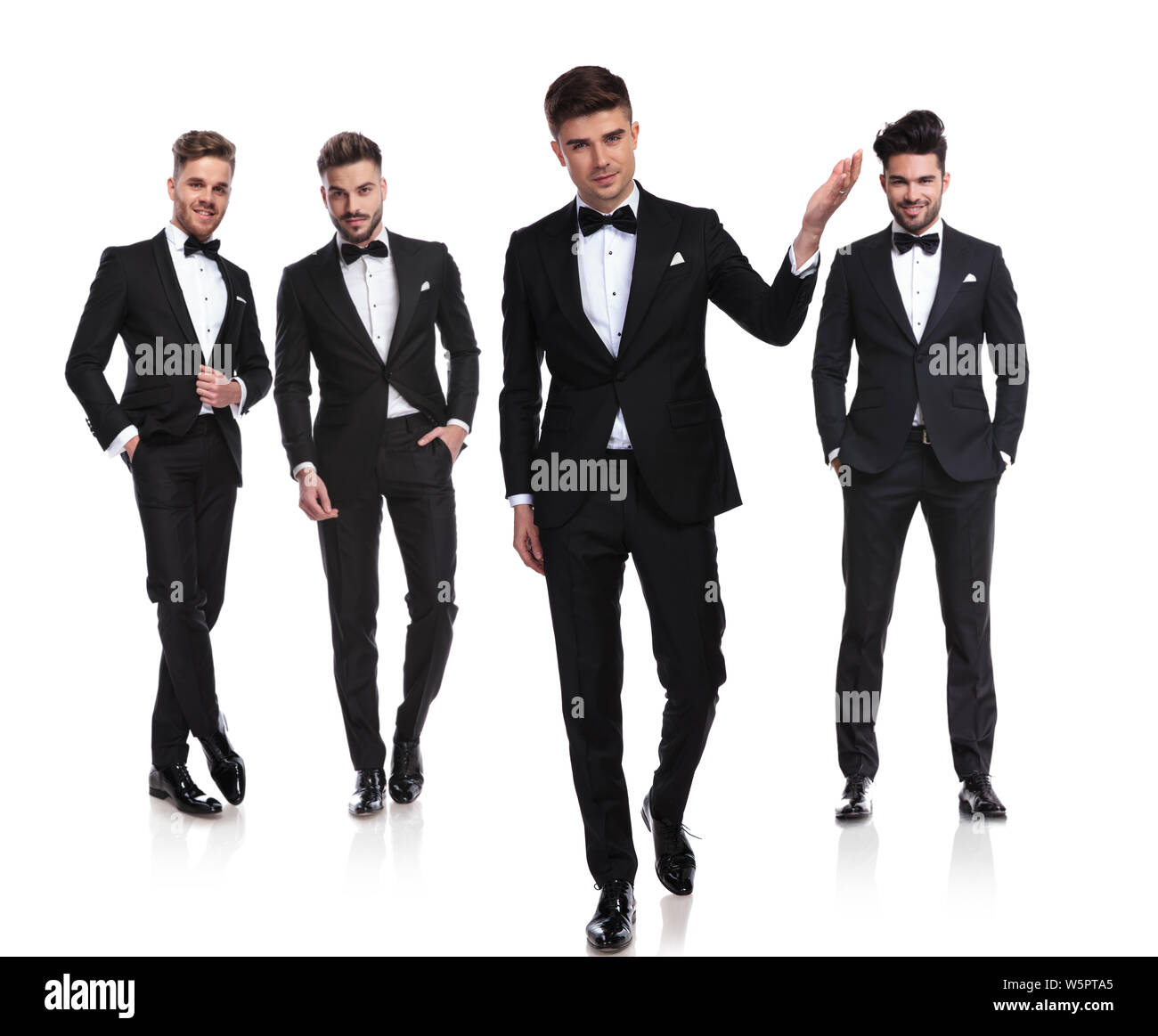 team of four gentlemen standing on white background with leader ...