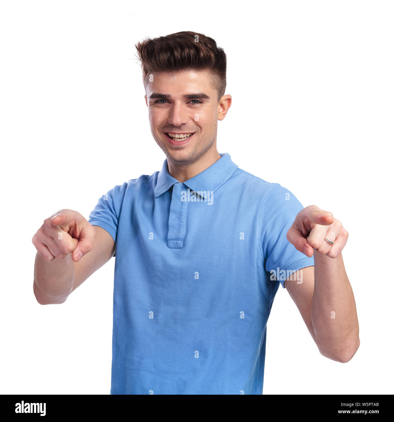 smiling casual man pointing his fingers at the camera on white ...