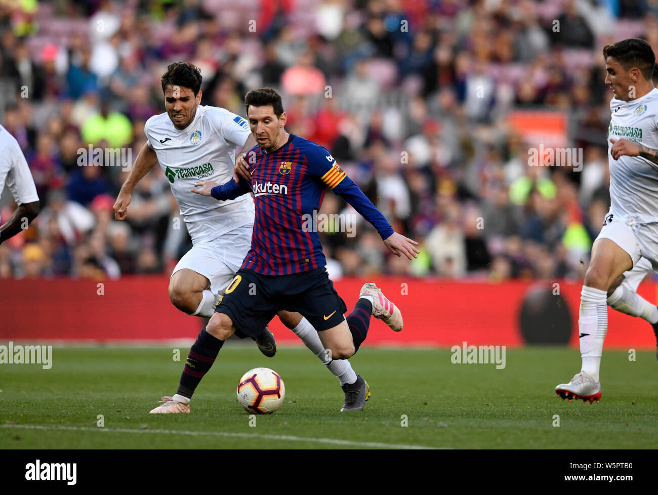 Lionel Messi, center, of FC Barcelona challenges Leandro Cabrera of ...