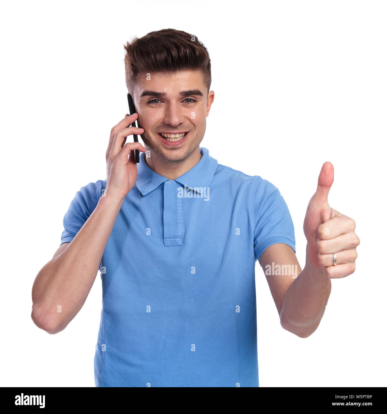 happy casual man talking on the phone makes the ok sign on white ...