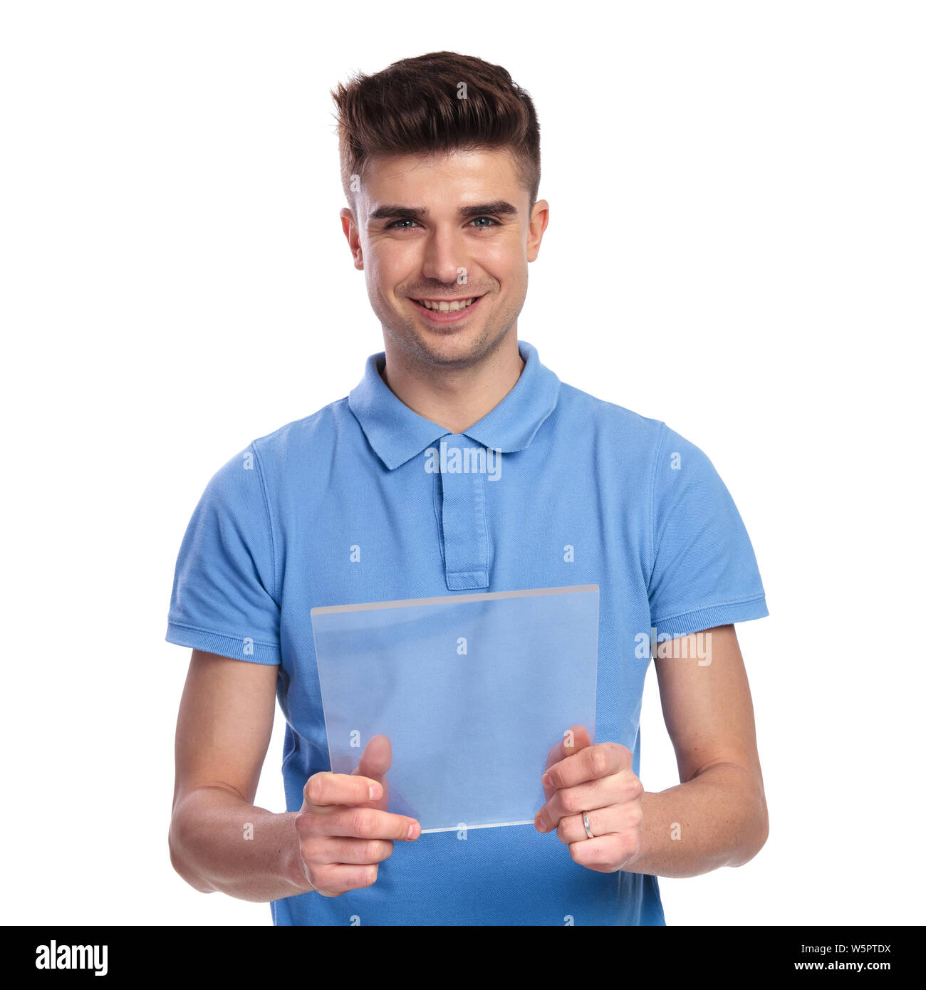 young smiling casual man holding futuristic tablet or gadget on white ...