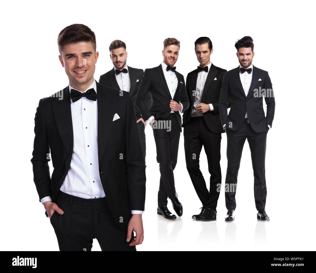 relaxed group leader of groomsmen stands in front of them and smiles ... relaxed group leader of groomsmen stands in front of them and smiles ...