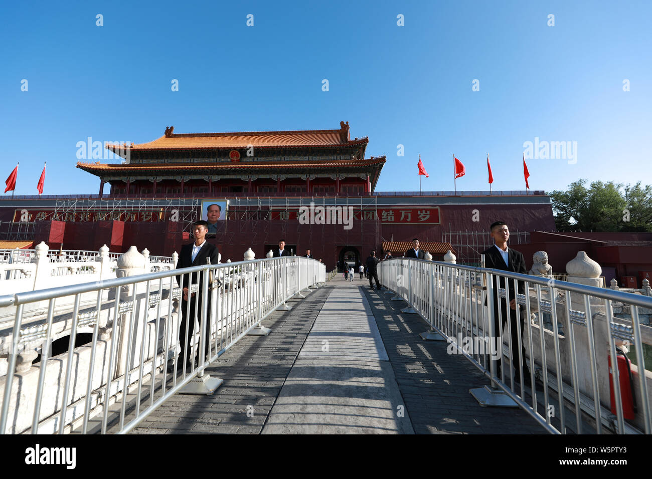 Chinese security guards stand in front of scaffoldings before the ...
