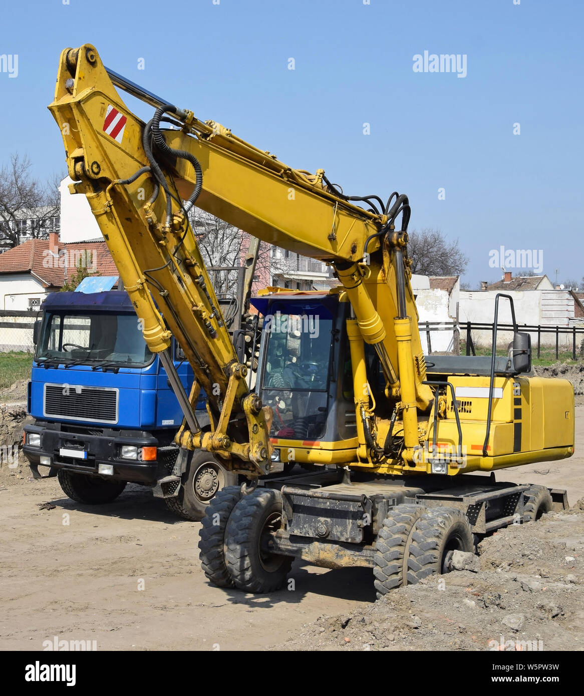 Excavator and truck at the road construction site Stock Photo - Alamy