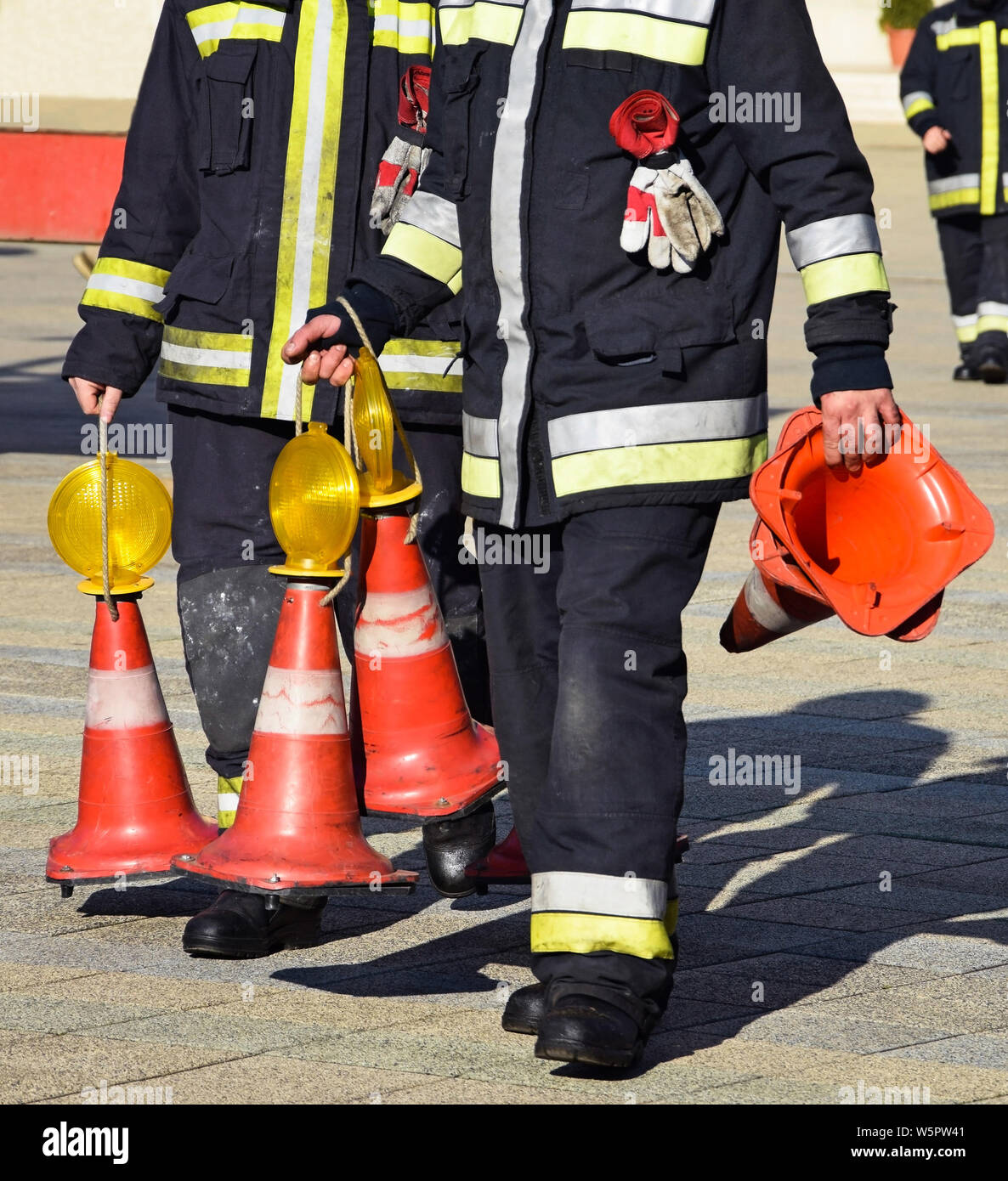 Firefighters with traffic cones at work Stock Photo - Alamy
