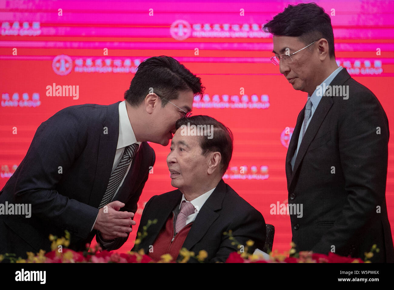 Lee Shau Kee, center, chairman of Henderson Land Development Co., and ...