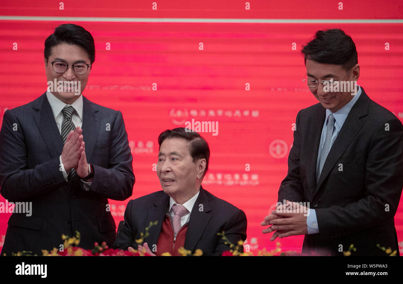 Lee Shau Kee, center, chairman of Henderson Land Development Co., and ...