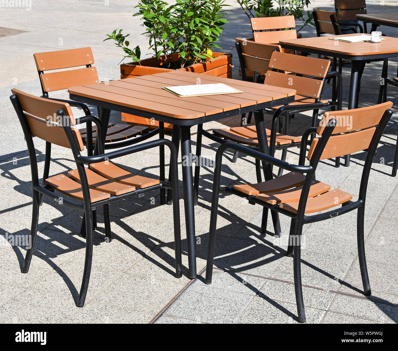 Tables and chairs on the street Stock Photo - Alamy